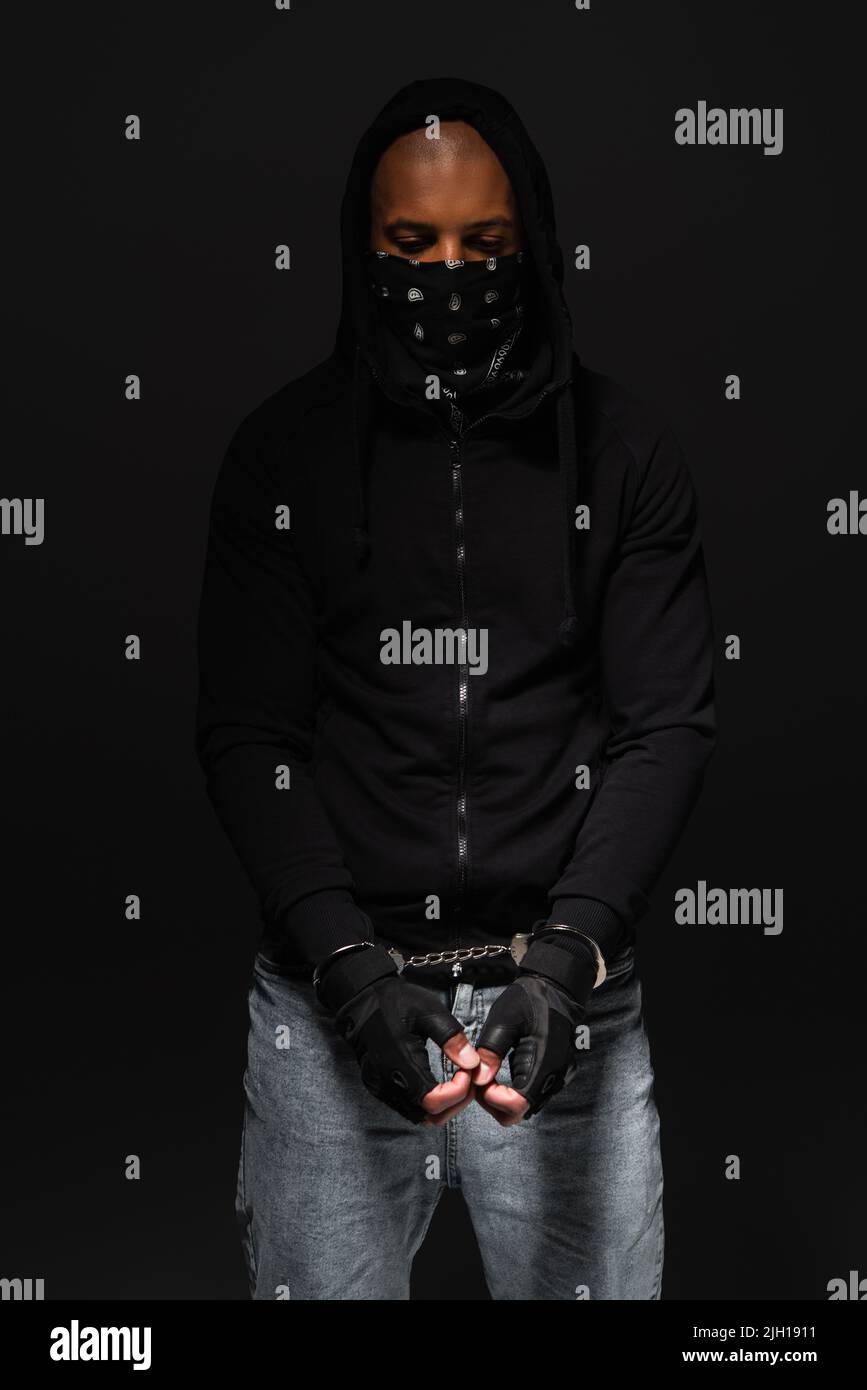 African american bandit with mask on face and handcuffs standing ...