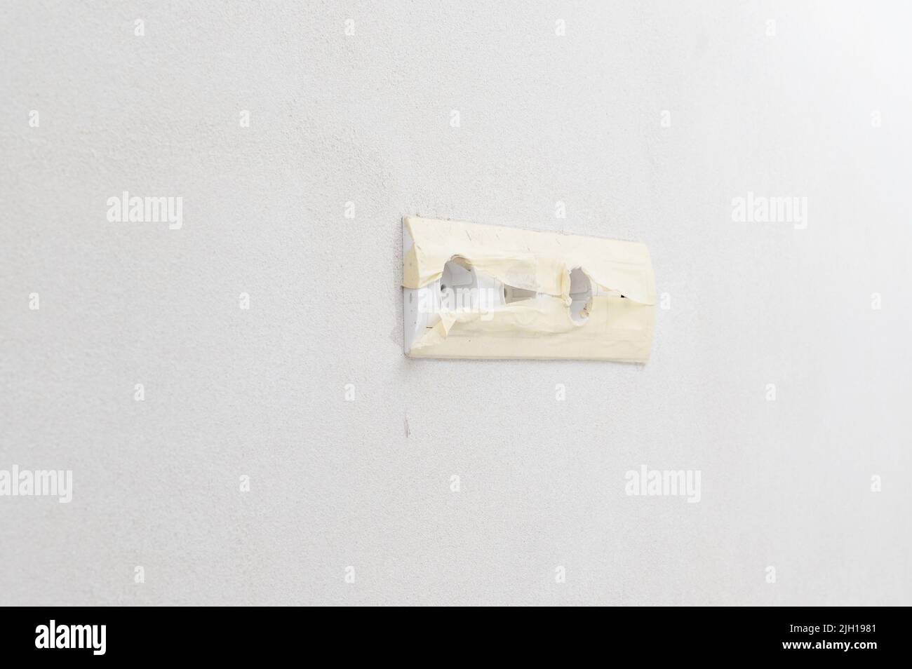 White sockets on a white wall, a socket for a TV antenna, sockets with ...