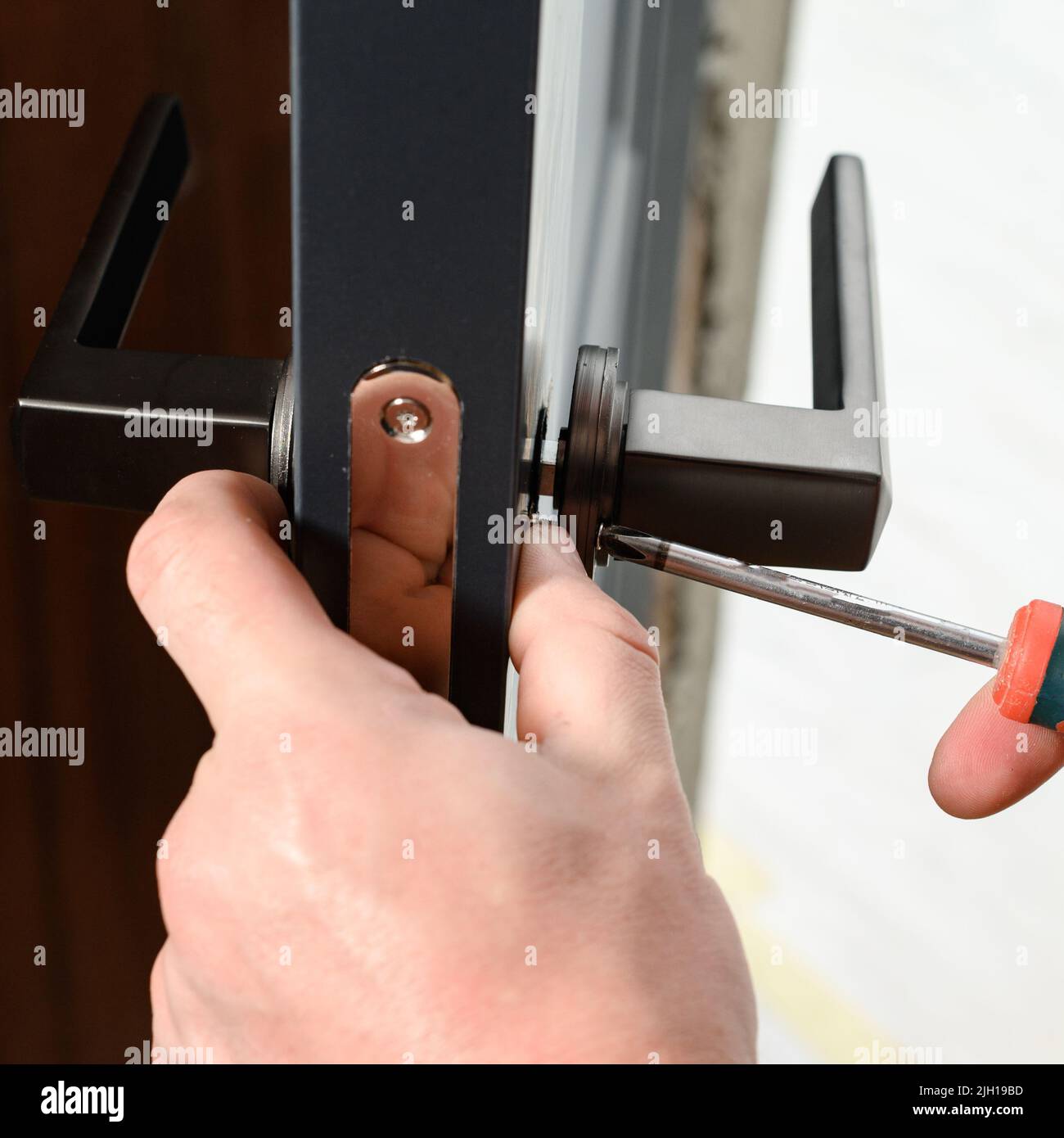 Construction worker installs door new hi-res stock photography and ...