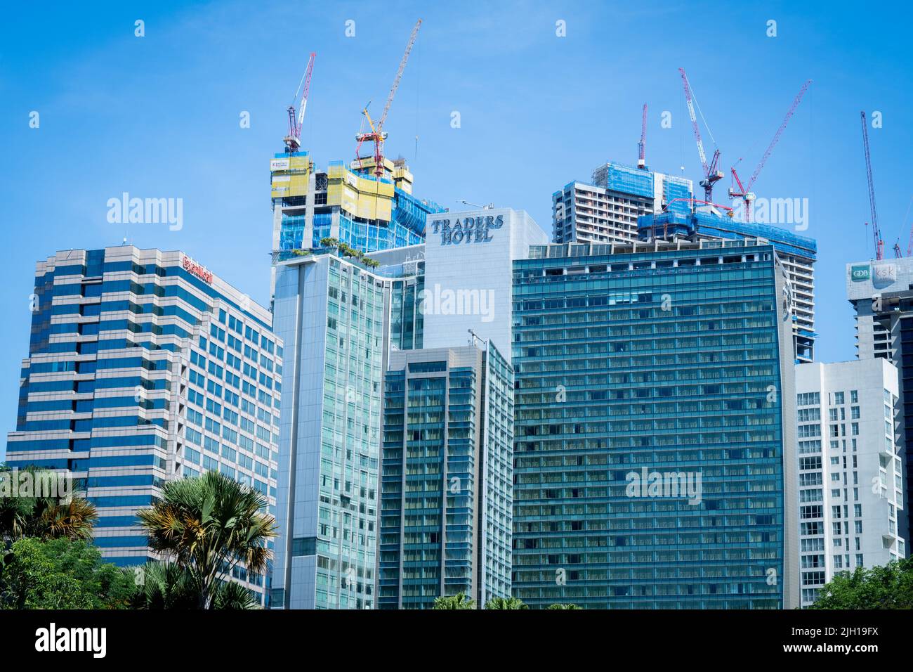 The Traders Hotel and other building against the blue sky background ...