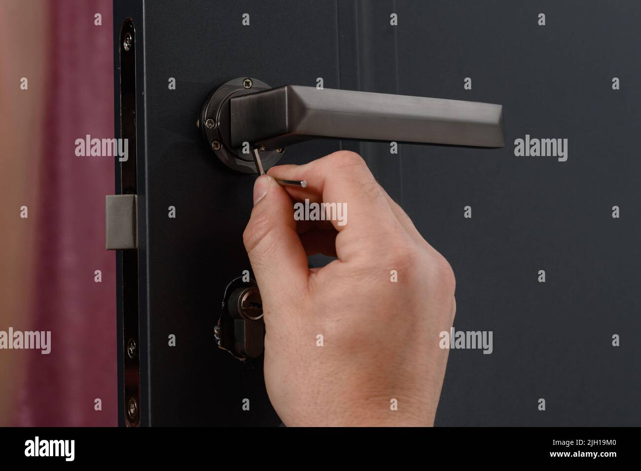 Hex key and installation of door lock and handle, close-up of ...