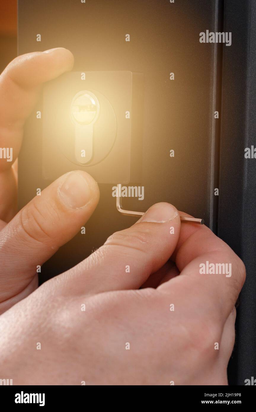 Hex key and installation of door lock and handle, close-up of ...