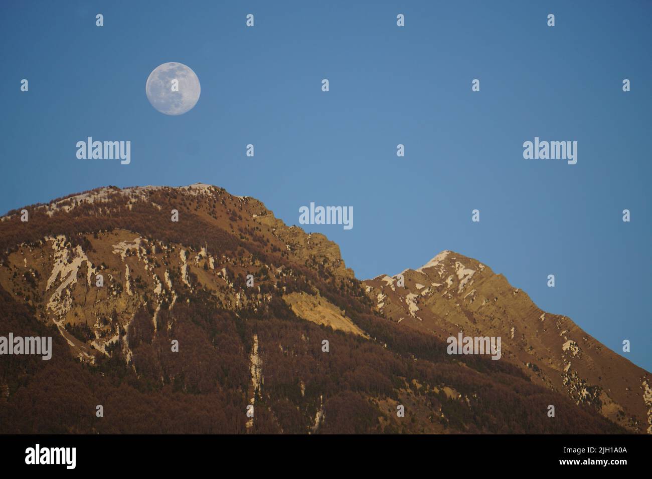full moon rising on the mountains of the alps france in the fall Stock ...