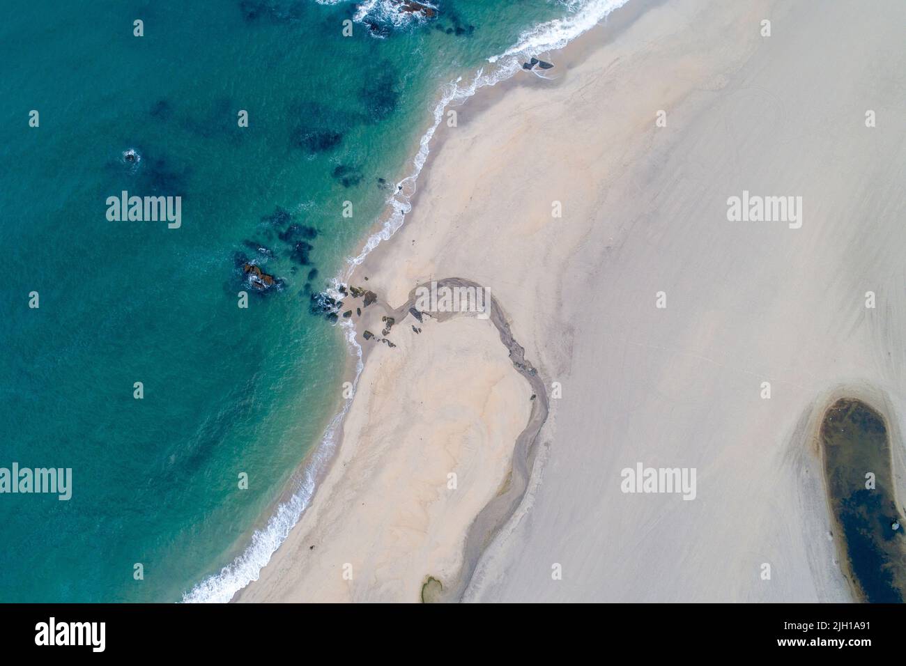 Aerial view of a beach with a small river Stock Photo - Alamy