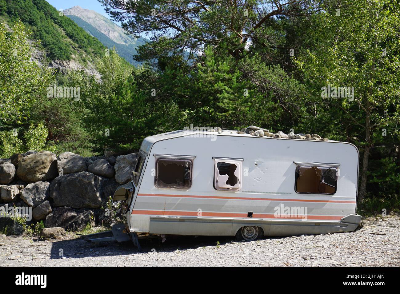 destroyed white caravan abandoned in the mountains of the alps, france ...