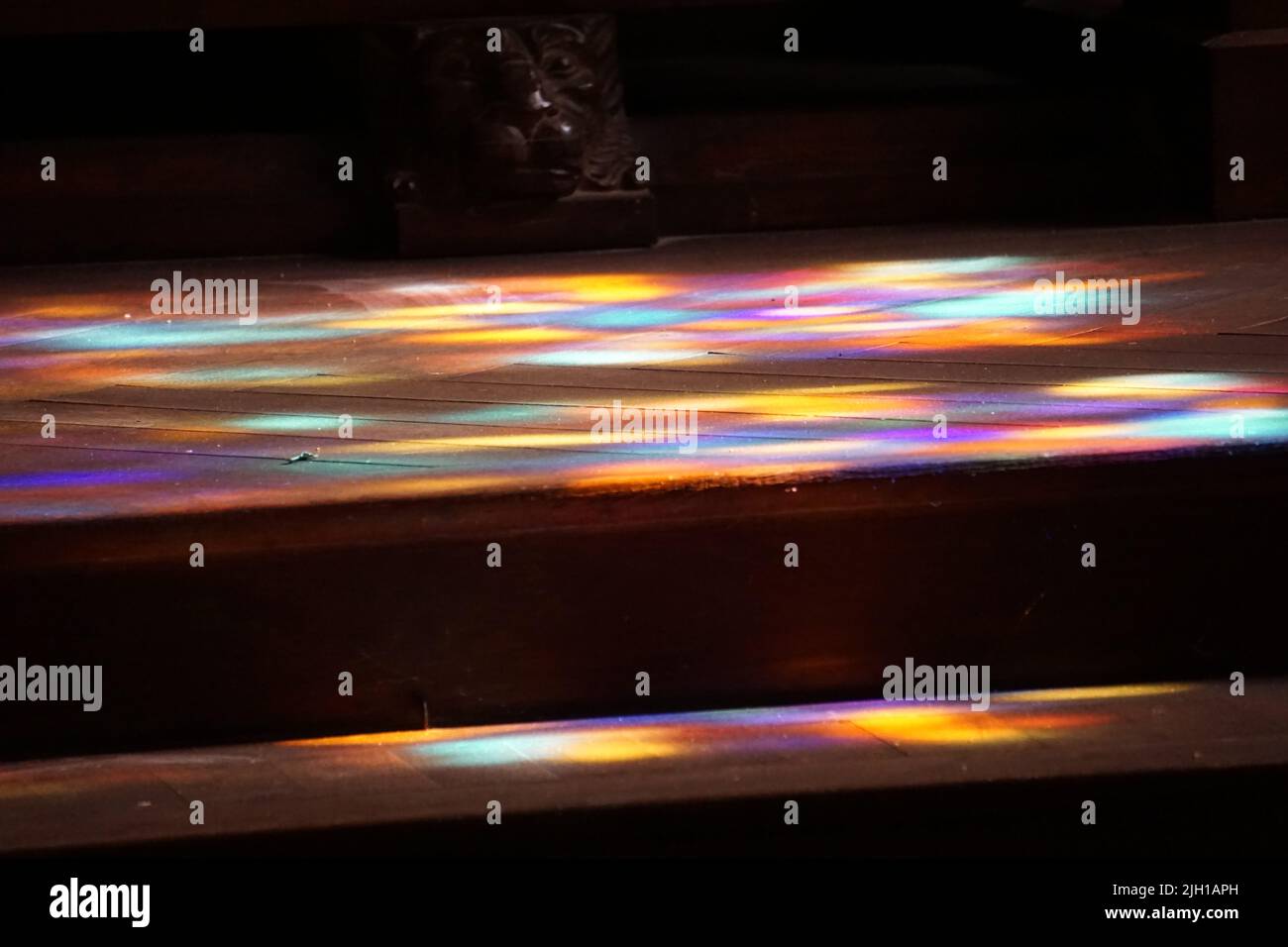 sun rays through colorful stained glass windows of a church appearing ...