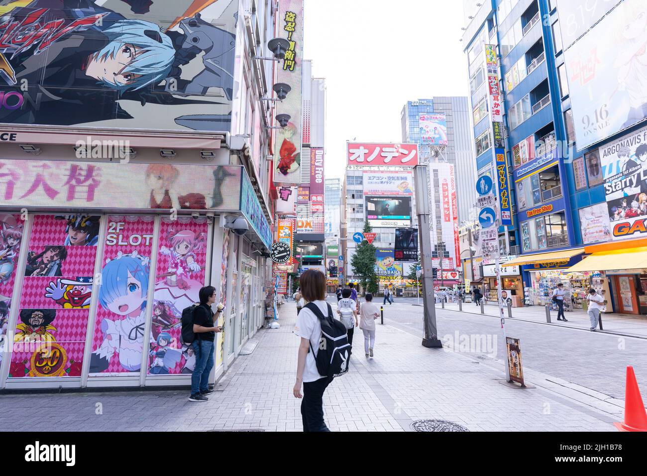 Akihabara, Japan- August 26, 2020: People walk near a pachinko building ...