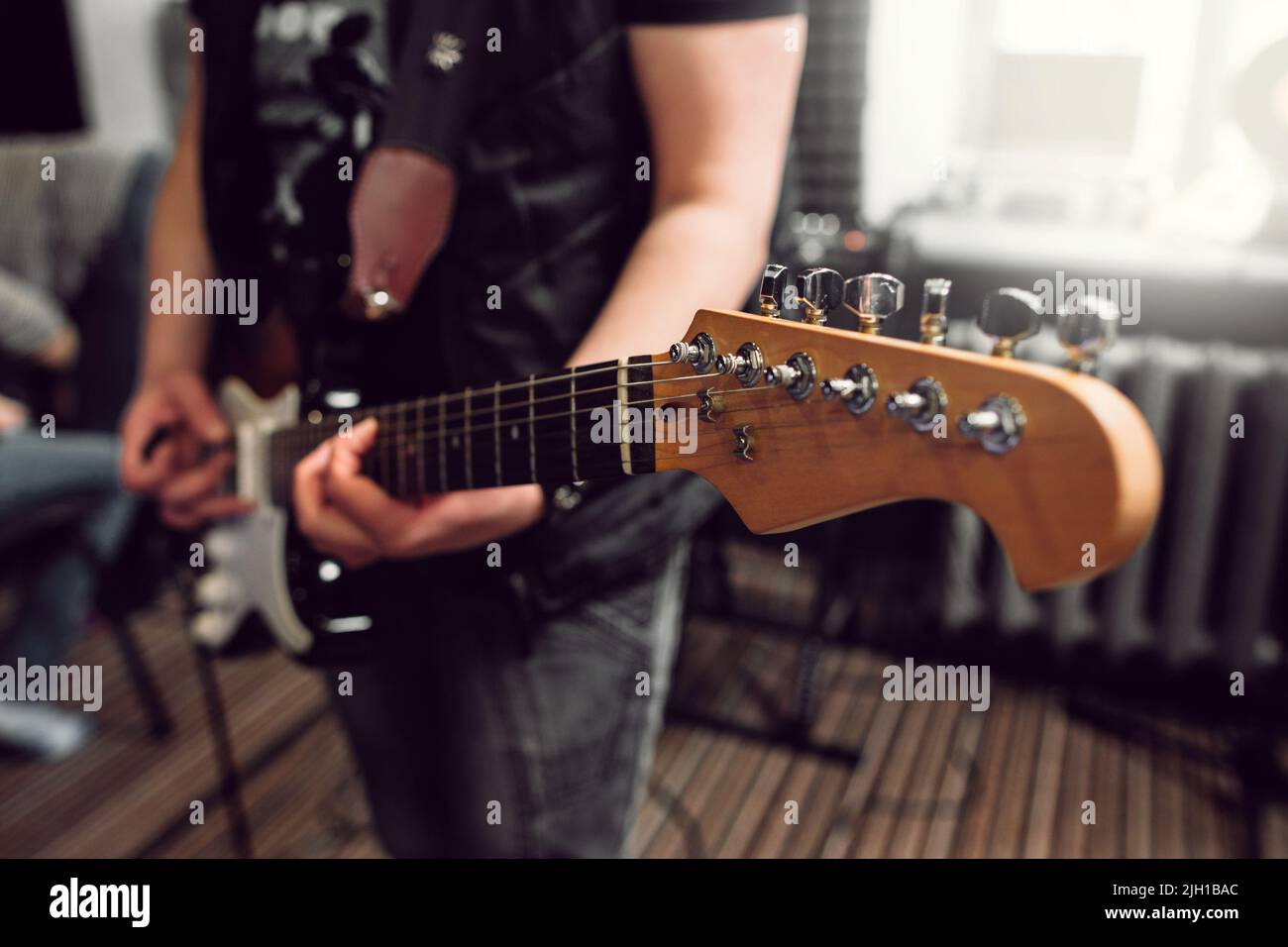 Bass guitar in playing musician hands close-up Stock Photo - Alamy