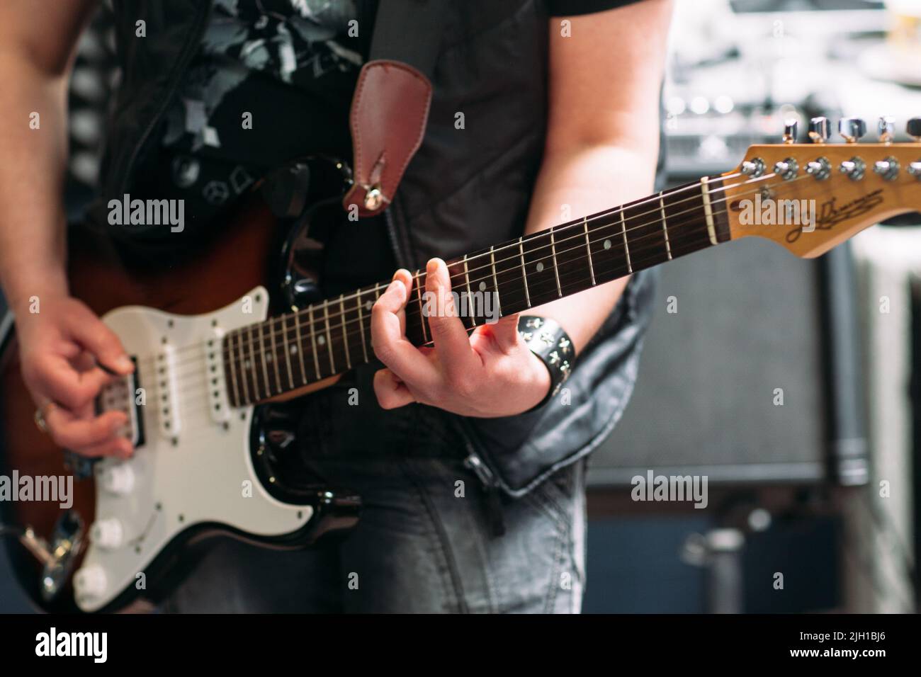 Rocker playing six string electric guitar Stock Photo - Alamy