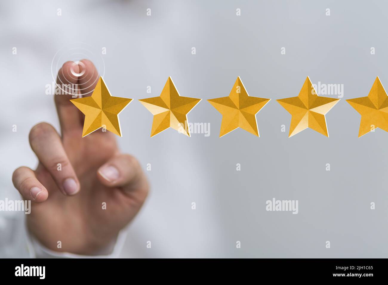 A person presenting a virtual projection of a five star rating Stock ...