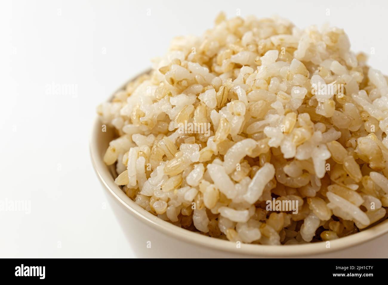 brown rice on a white background Stock Photo - Alamy