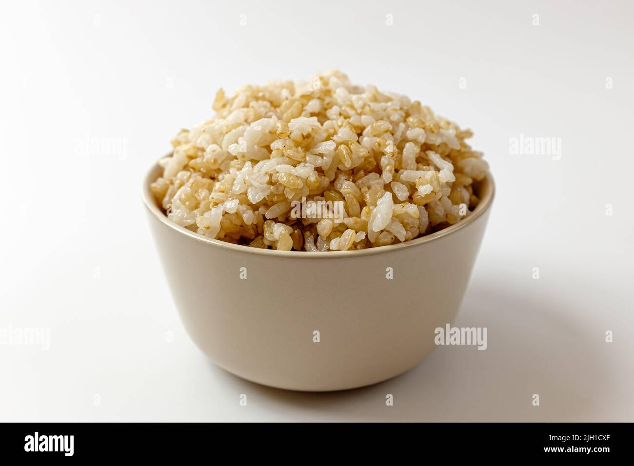 brown rice on a white background Stock Photo - Alamy