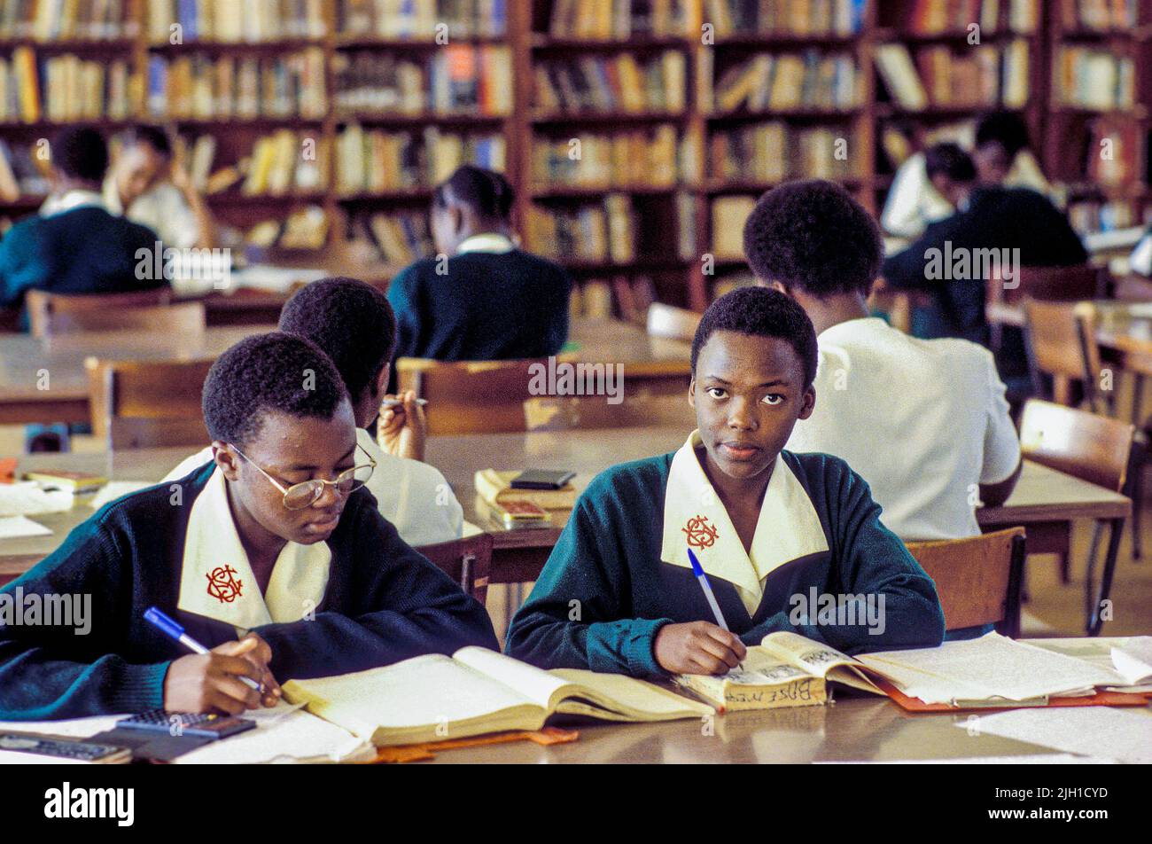 Uganda, Kampala; portrait of two girls at the library of a girls school ...