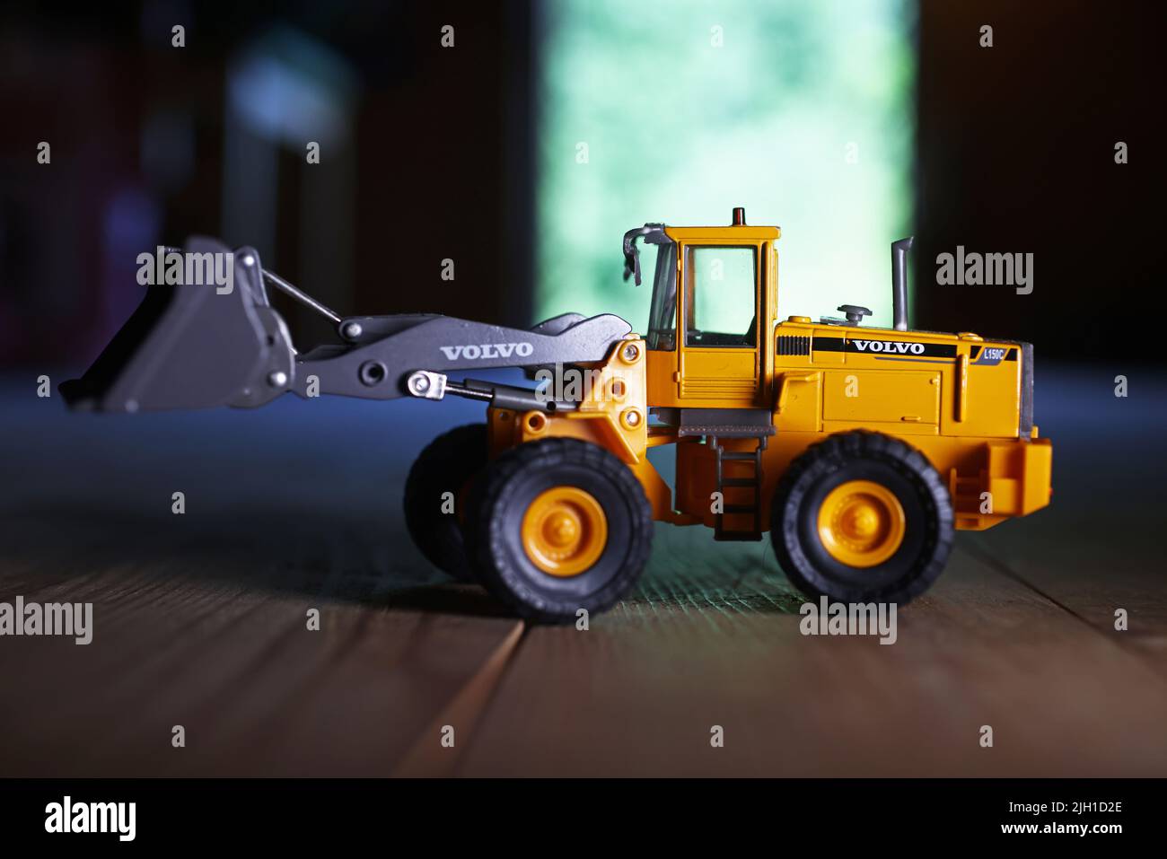 Toys in a box in an attic of a house. Here are small toy cars, a wheel ...