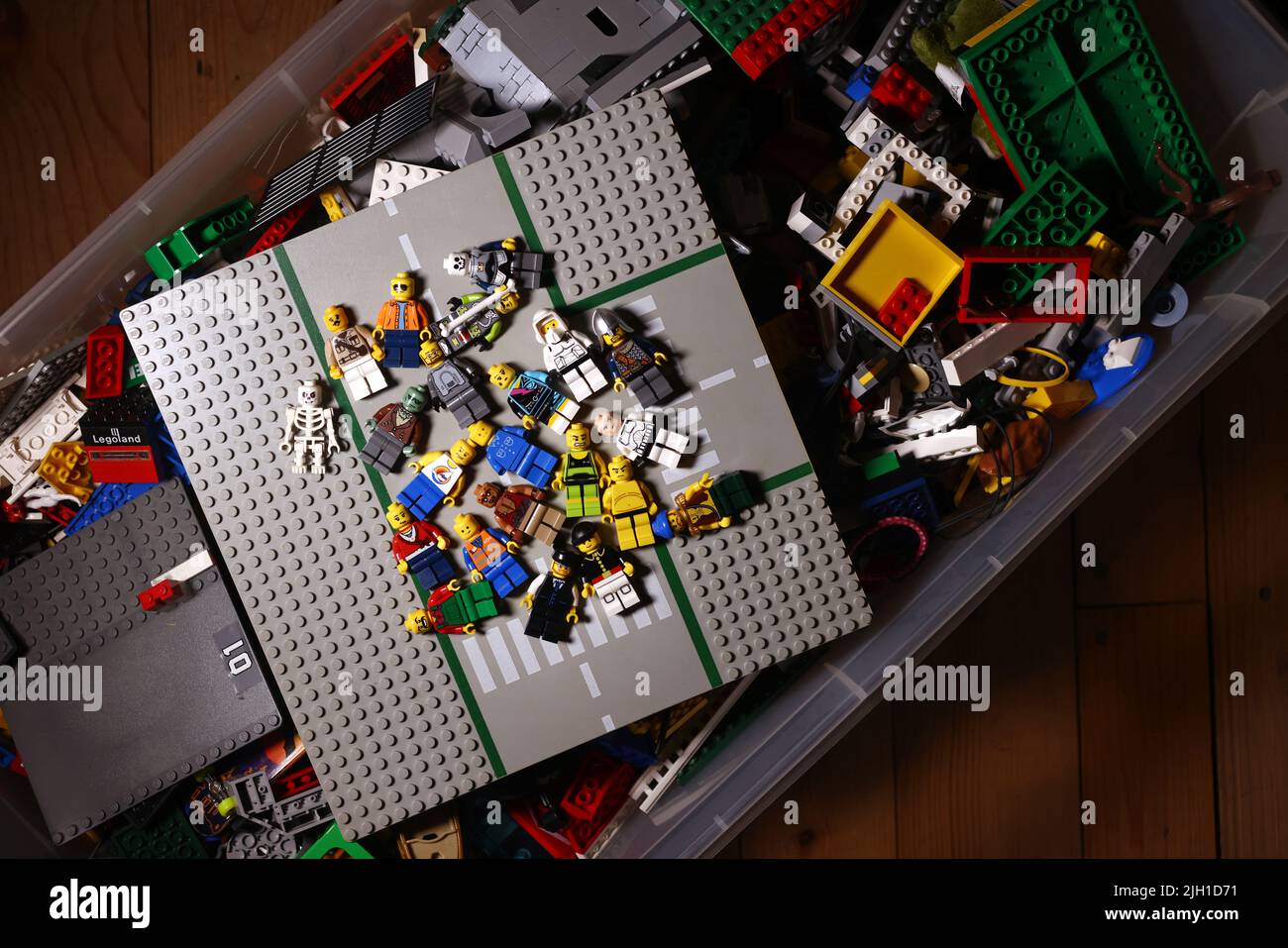 Toys in a box in an attic of a house. Lego, a line of plastic ...