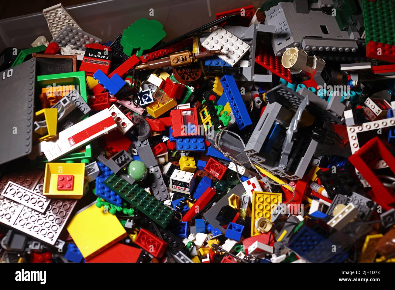 Toys in a box in an attic of a house. Lego, a line of plastic ...