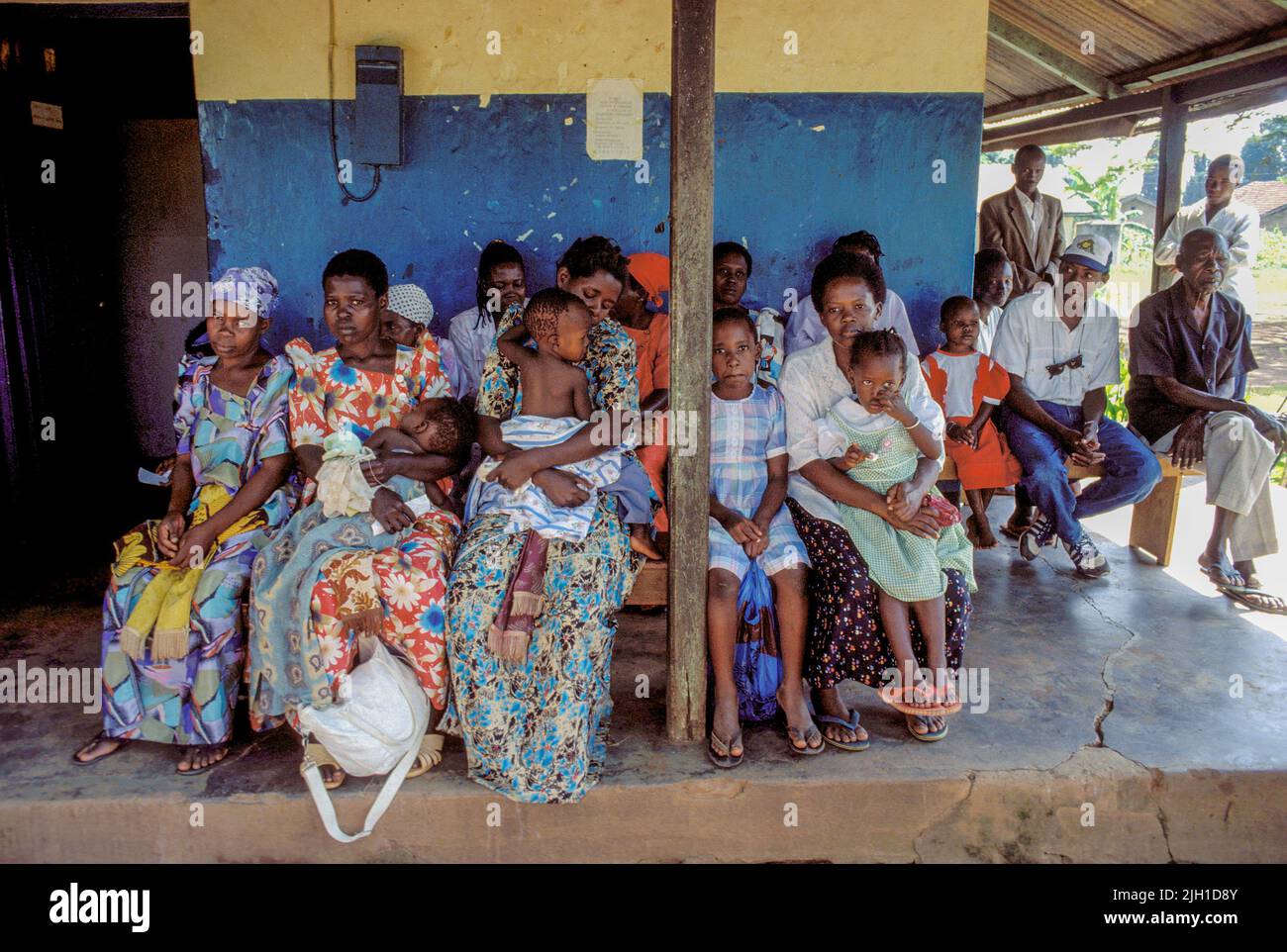 Uganda, Kampala region; Mothers and children waiting outside at a ...