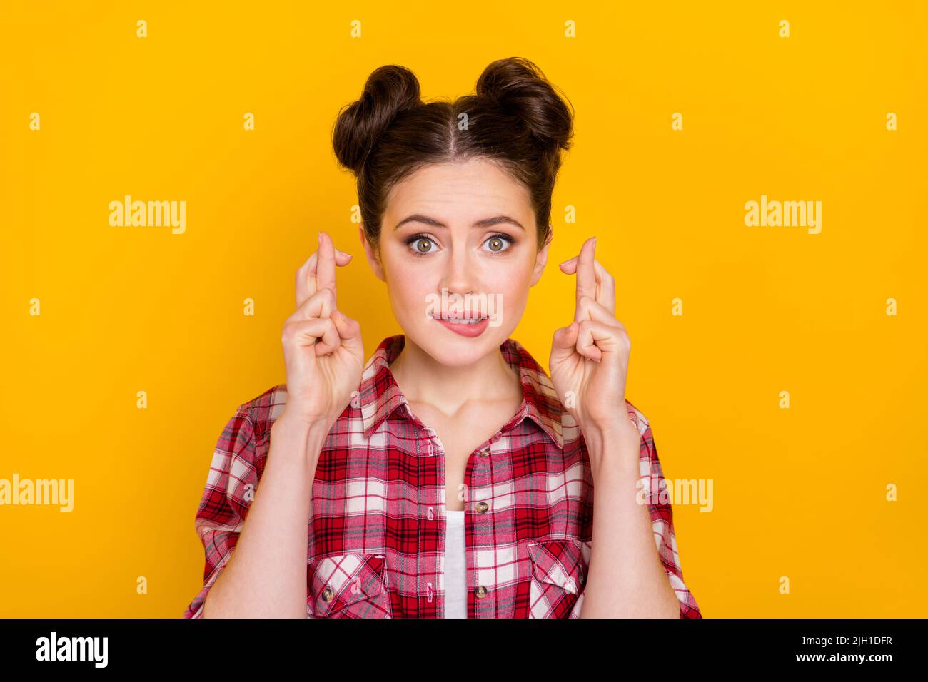 Portrait of pretty worried lady biting lip crossed fingers look camera ...