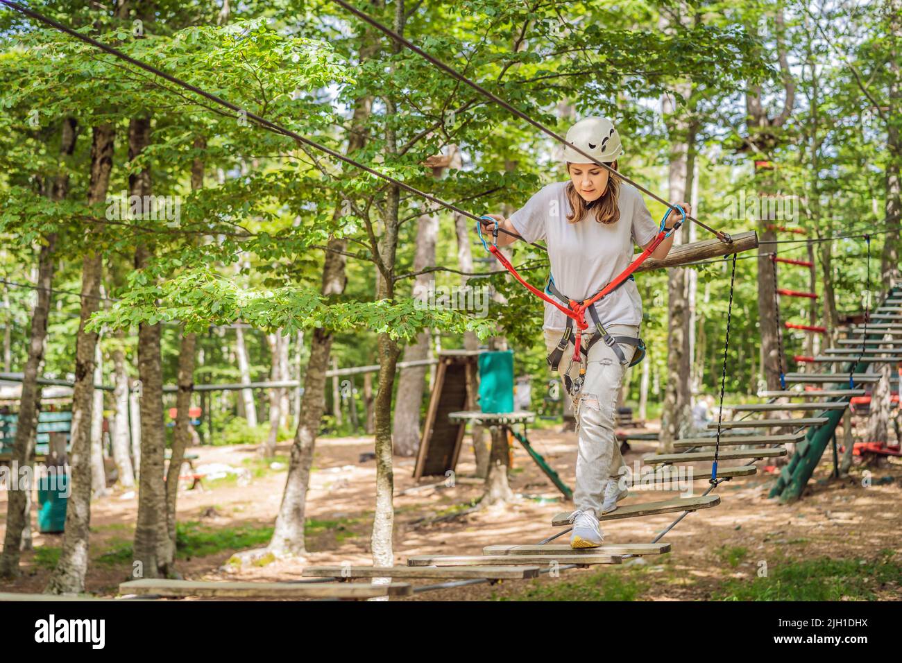 Happy women girl female gliding climbing in extreme road trolley ...