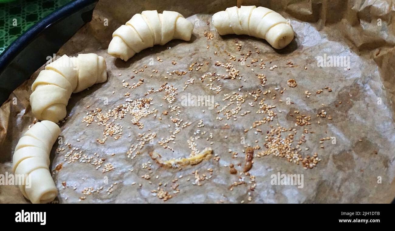 Croissants on a baking paper ready for oven .Homemade pastry with ...