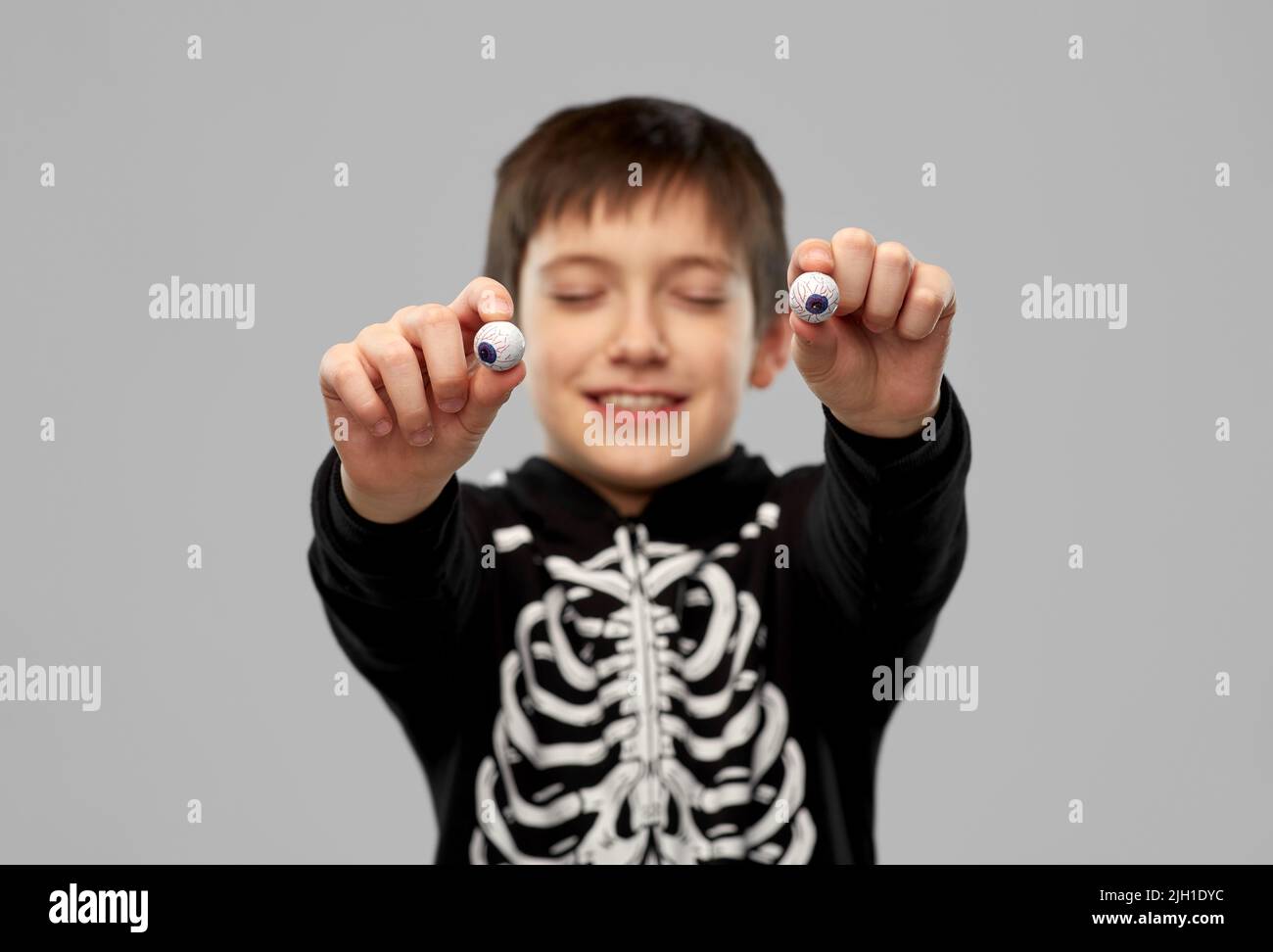 boy in halloween costume with eyeball candies Stock Photo - Alamy