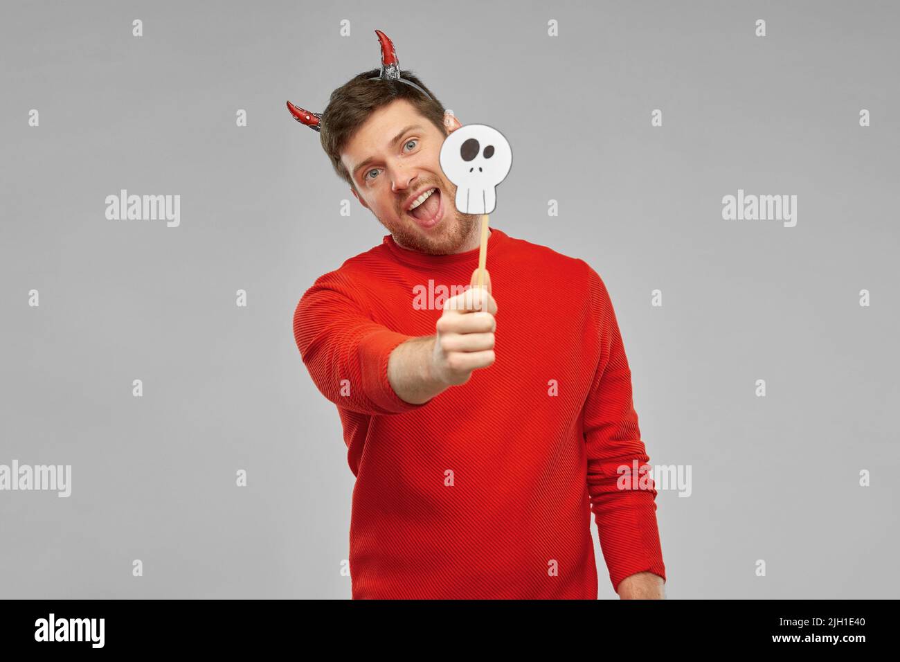 happy man in halloween costume of devil over grey Stock Photo - Alamy