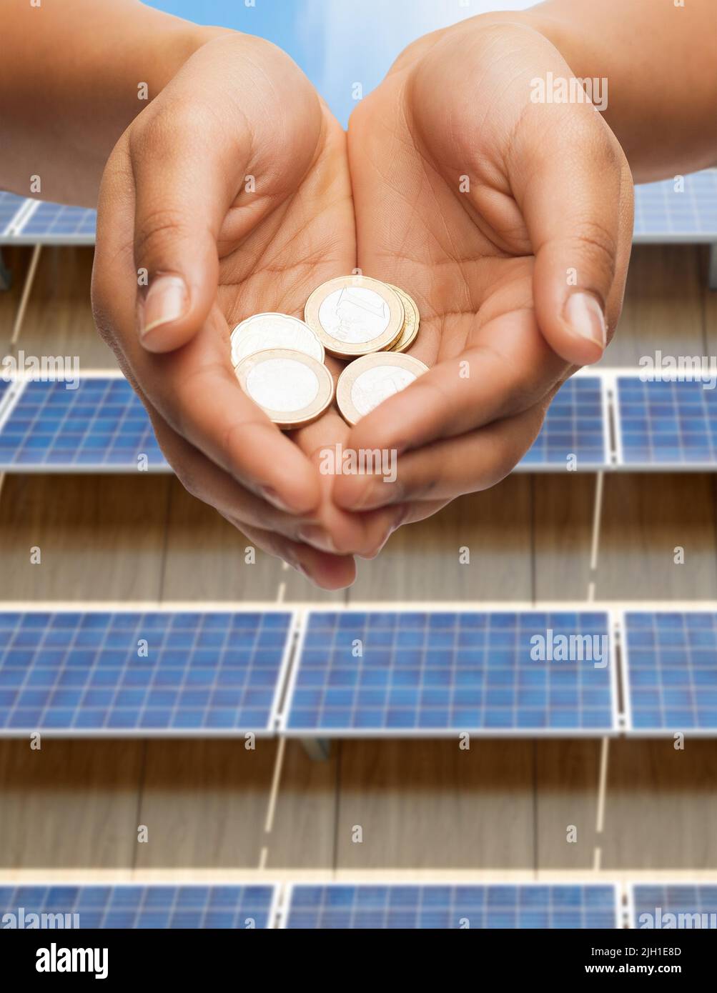 hands holding money over solar panels Stock Photo - Alamy