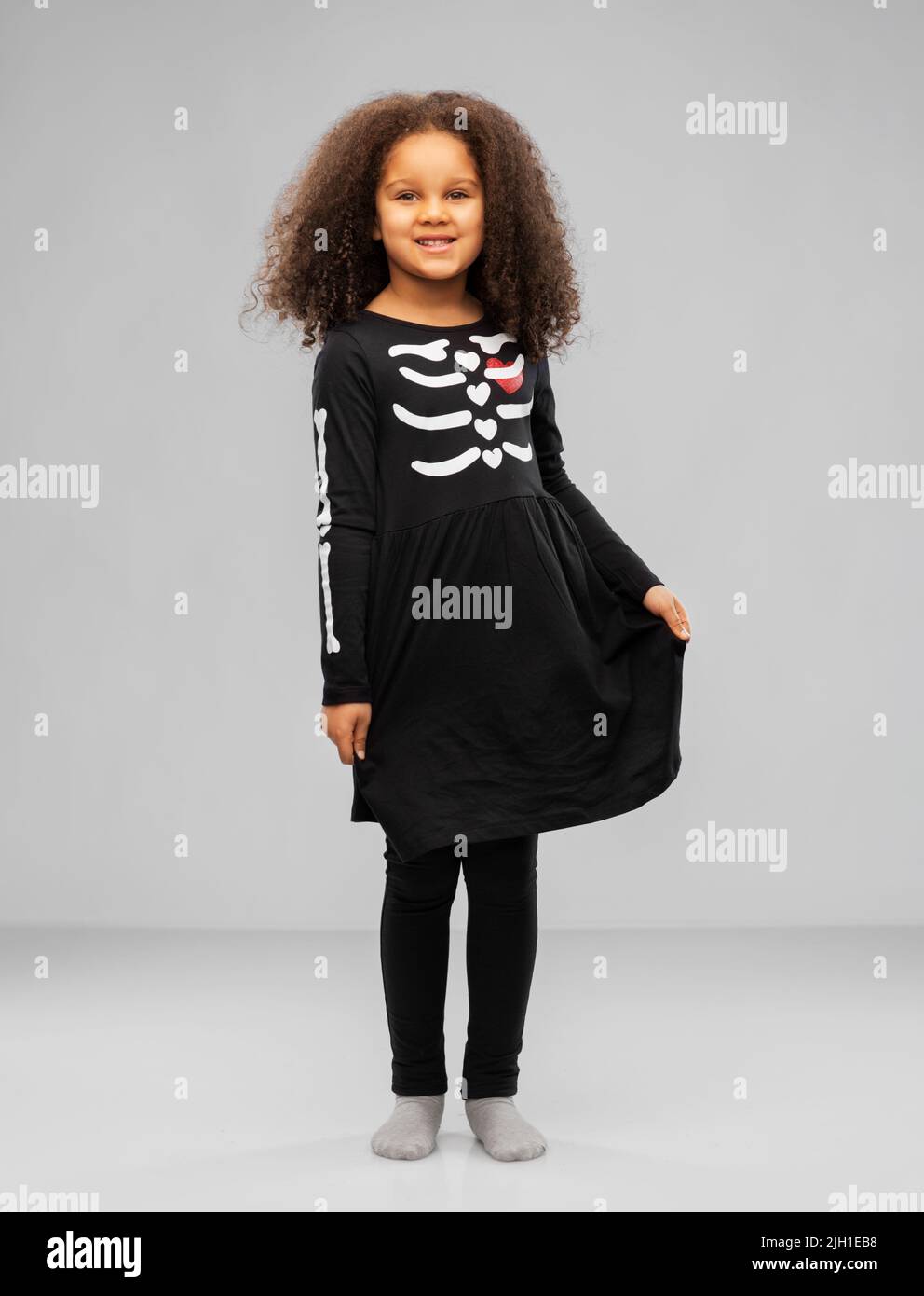 girl in black halloween dress with skeleton bones Stock Photo - Alamy