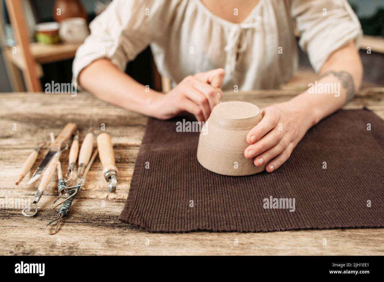 Pottery making at studio, decoration process. Close-up of artisan ...