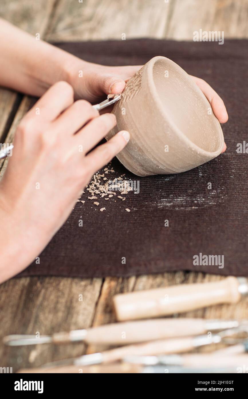 Carving on clay bowl, pottery decorating Stock Photo - Alamy