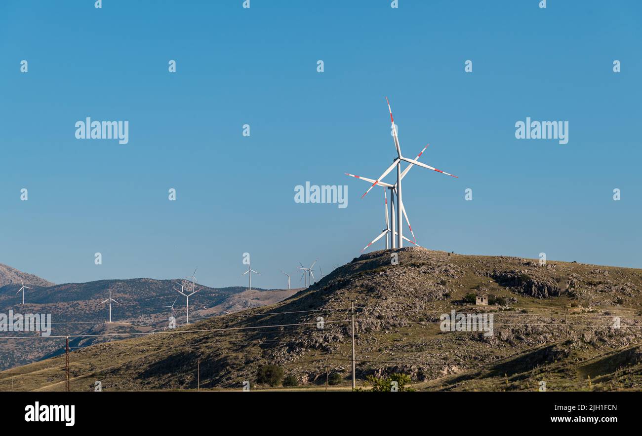clean electricity producing wind turbine or windmill built on a windy ...