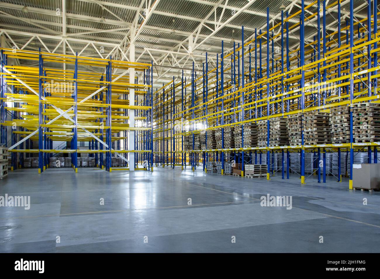 Interior of a modern warehouse storage of retail shop with pallet truck ...