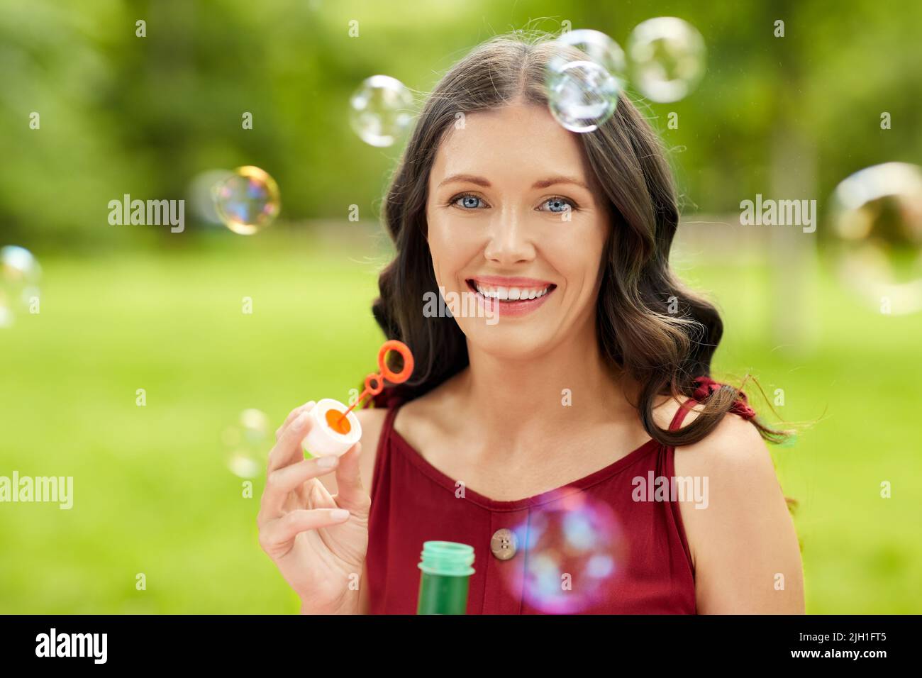 Beautiful female blowing soap bubbles hi-res stock photography and ...