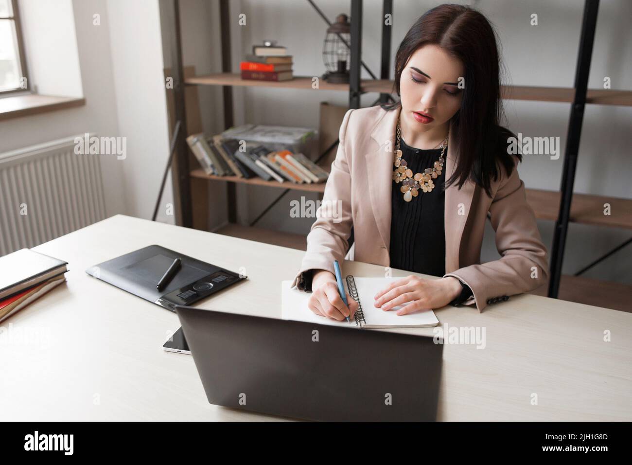 Female cartoonist drawing at office. Creative woman illustrator ...