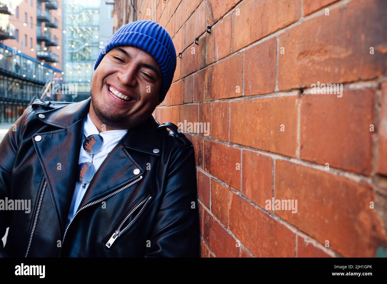 Red brick wall man standing hi-res stock photography and images - Alamy