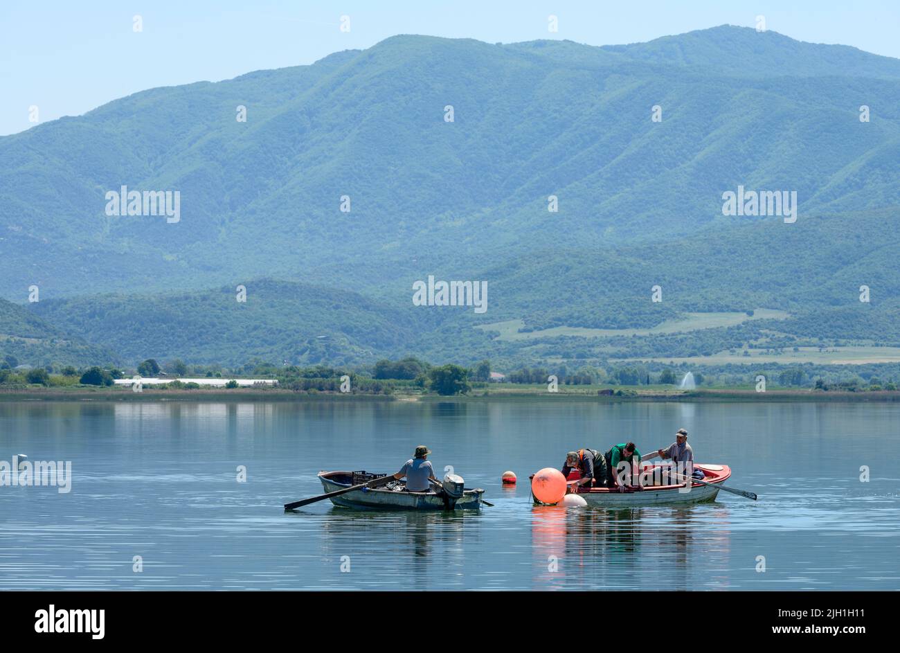Boatmen working on Lake Volvi at the village of Mikri Volvi at the top ...