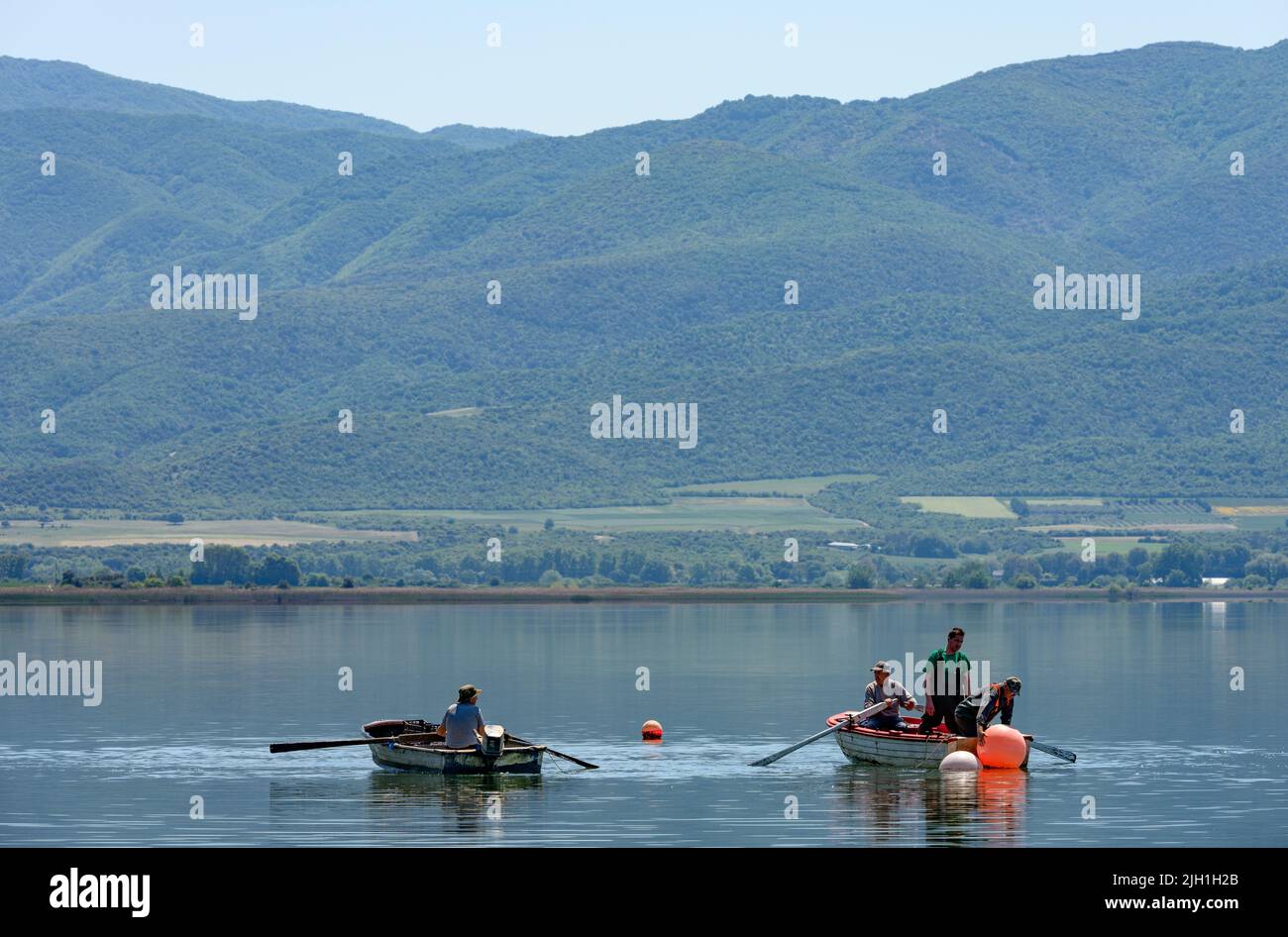 Boatmen working on Lake Volvi at the village of Mikri Volvi at the top ...