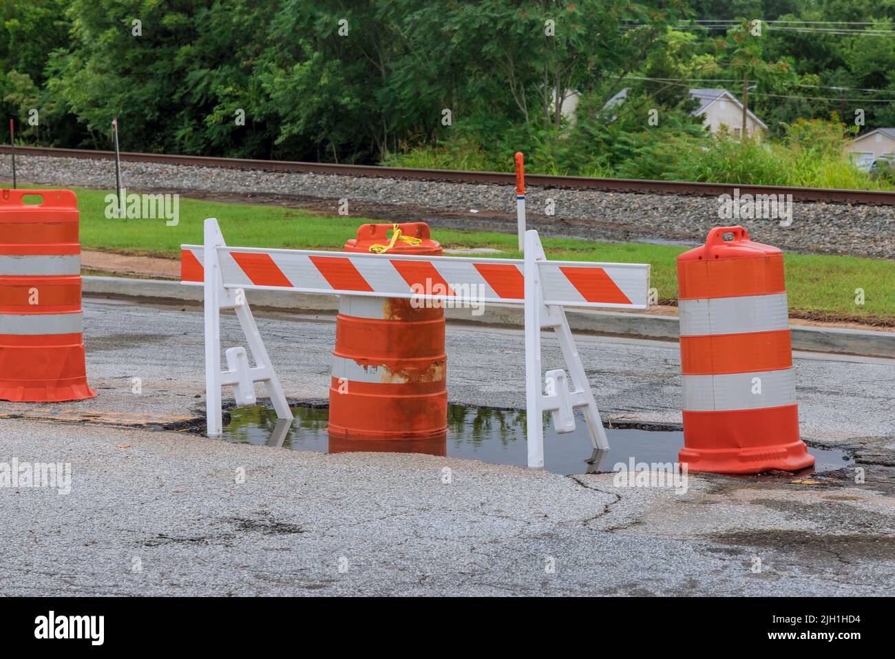Road repair pits with signs for bypassing the repair site at the side ...