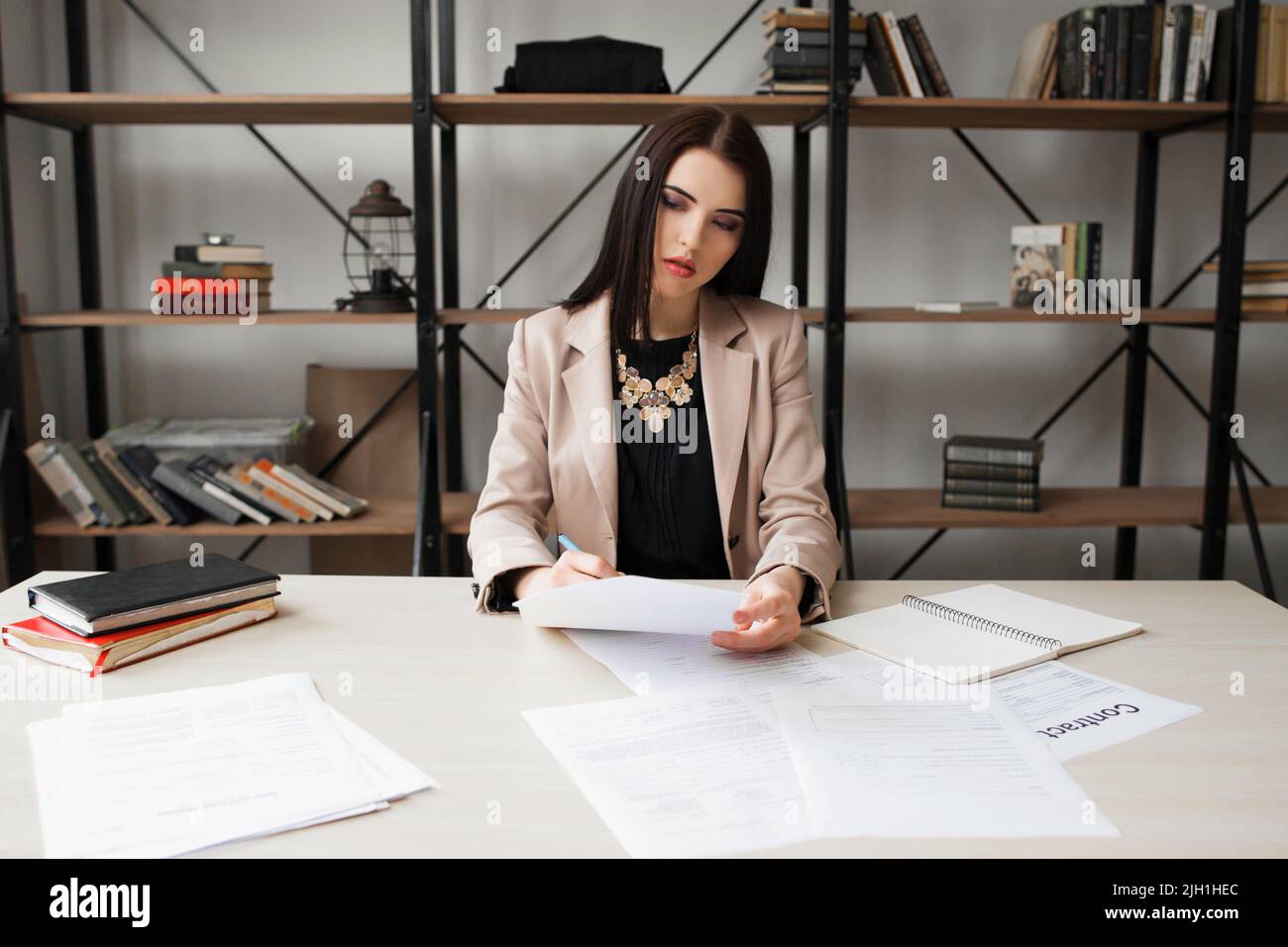 Successful business woman checking documentation Stock Photo - Alamy