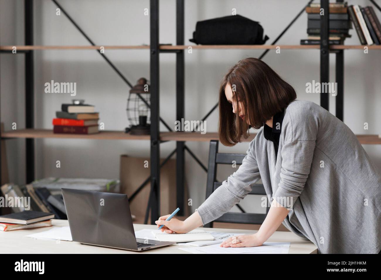 Woman standing in busy office hi-res stock photography and images - Alamy