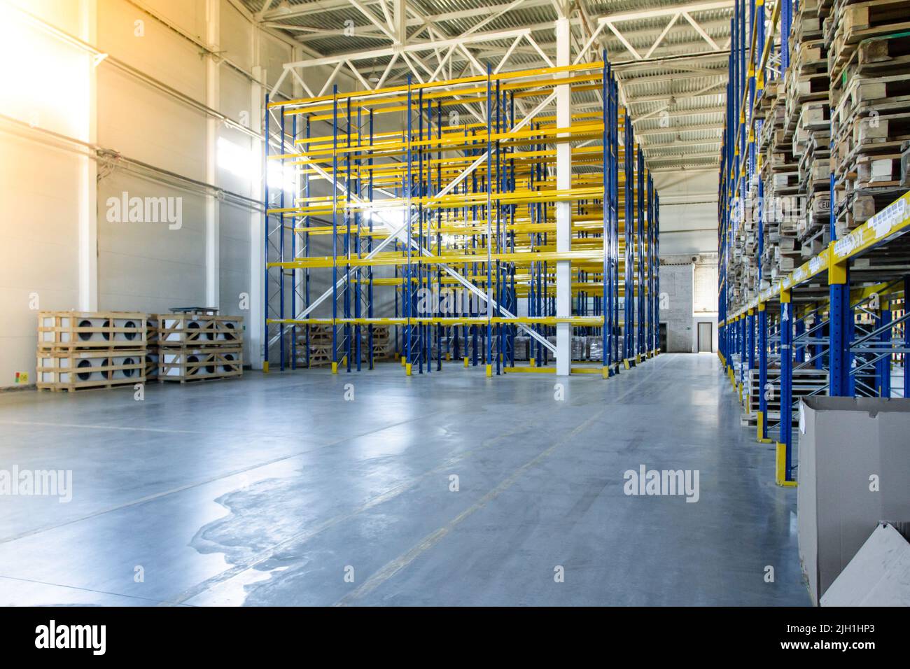 Interior of a modern warehouse storage of retail shop with pallet truck ...