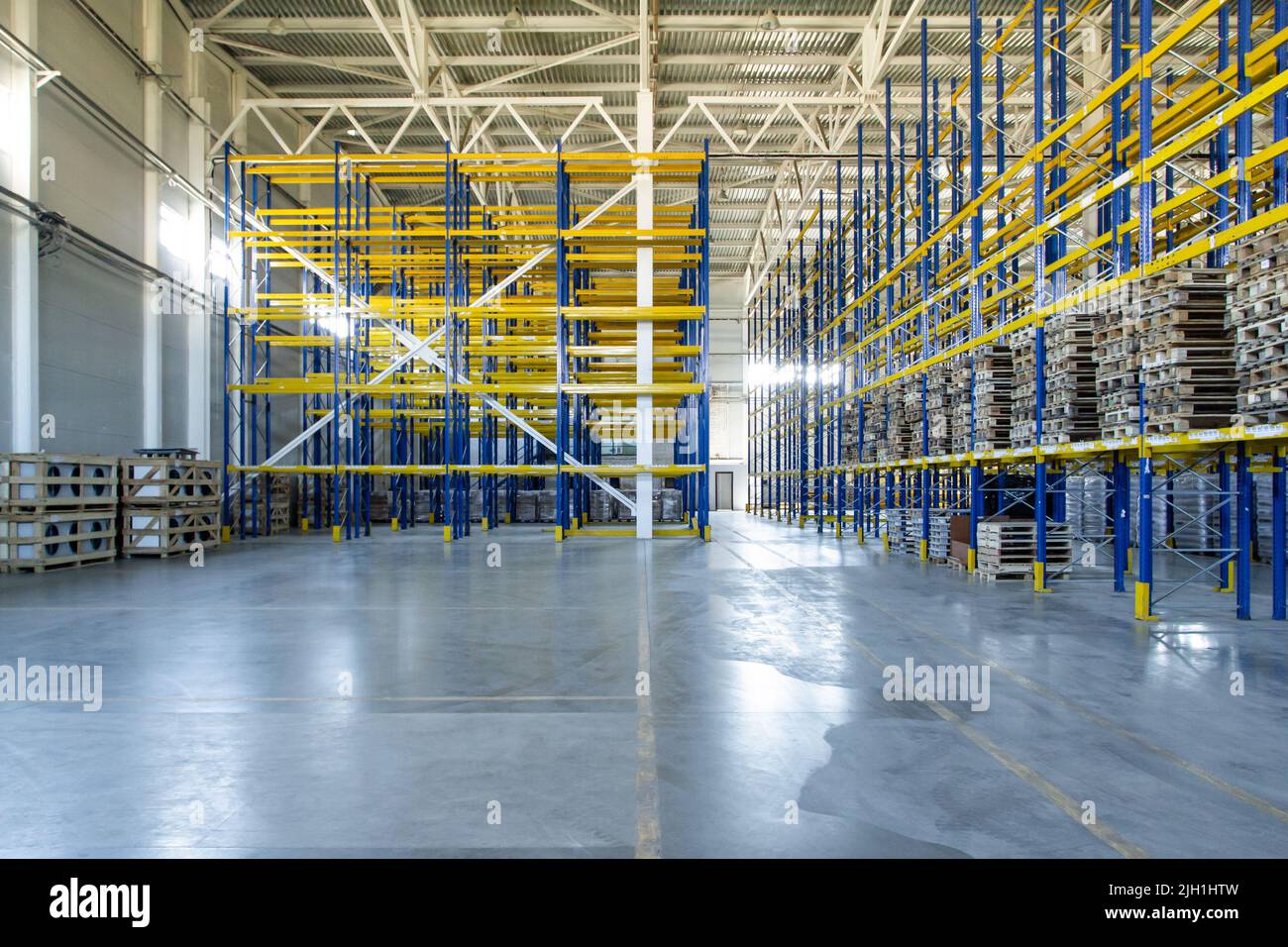Interior of a modern warehouse storage of retail shop with pallet truck ...