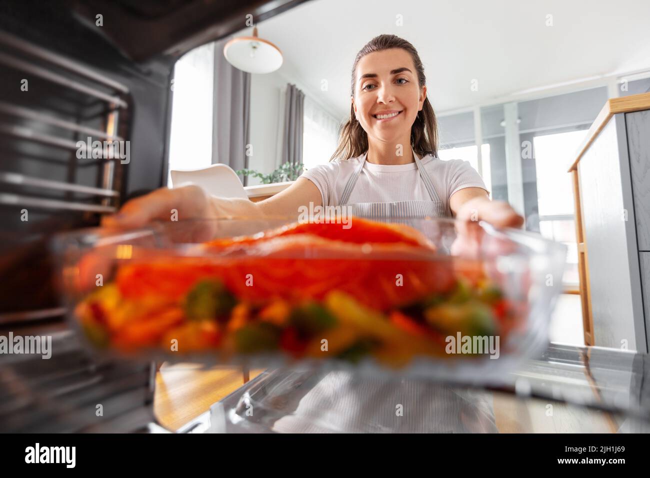 woman cooking food in oven at home kitchen Stock Photo - Alamy