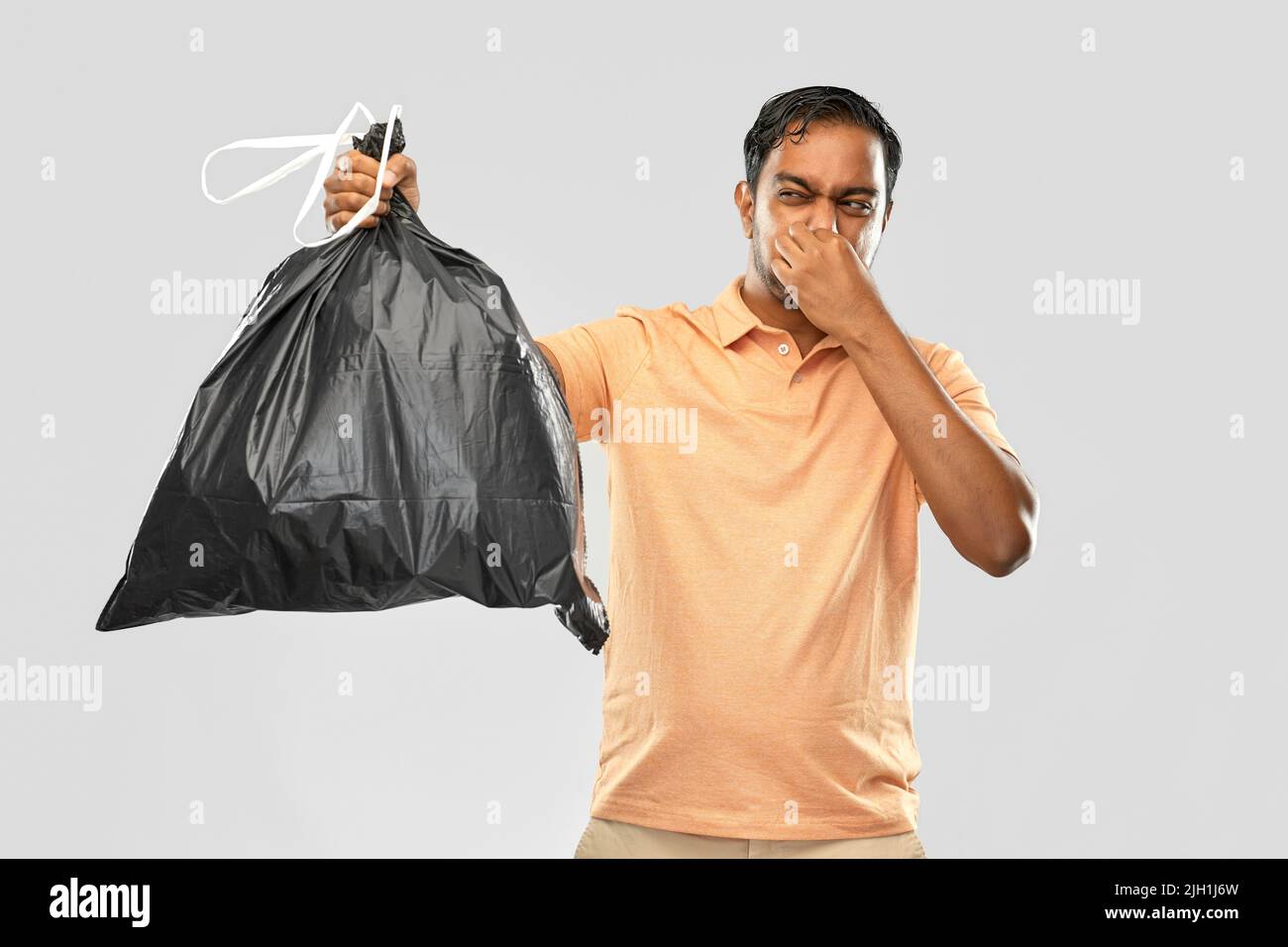 indian man holding stinky trash bag Stock Photo - Alamy