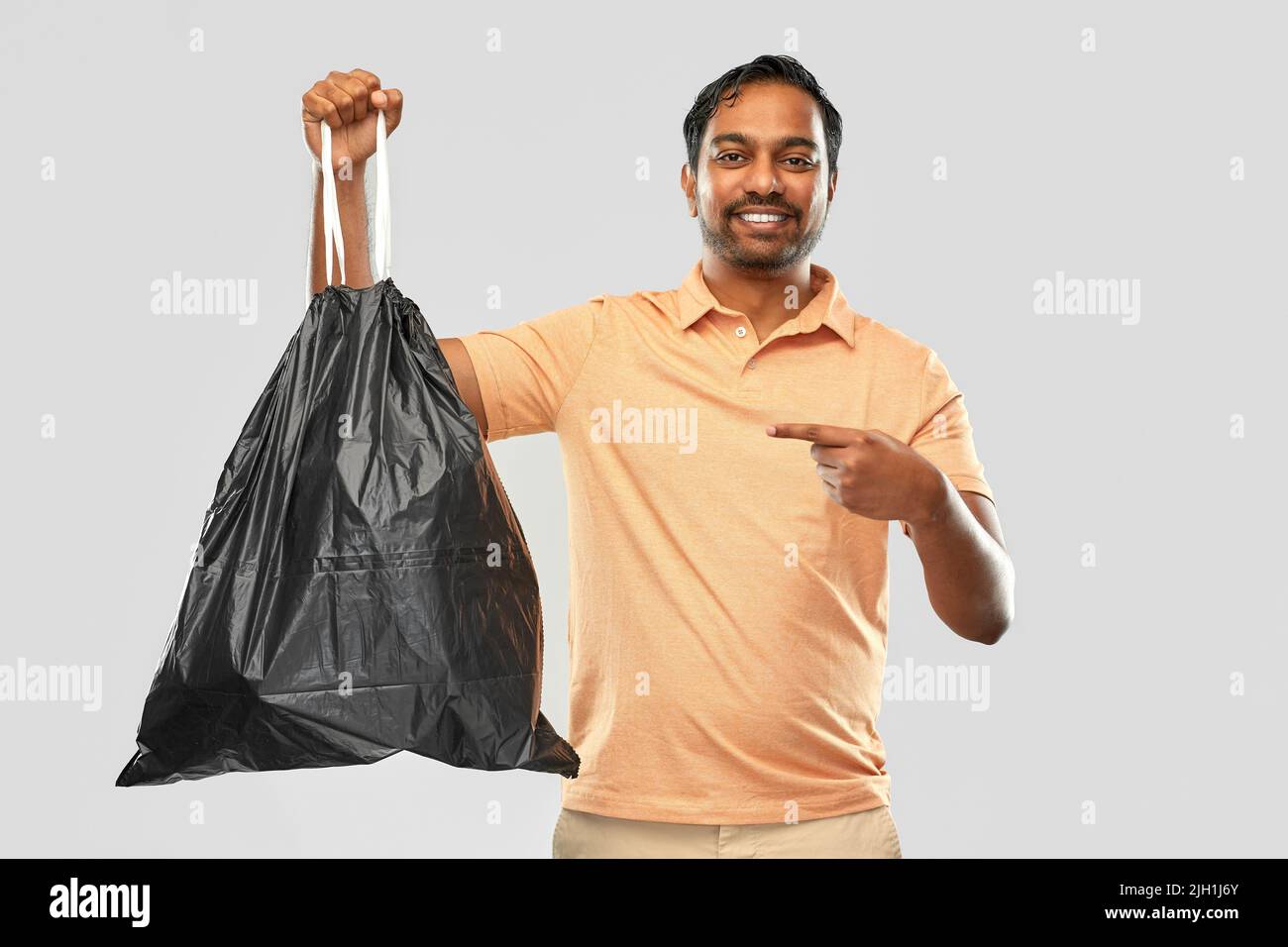 smiling indian man holding trash bag Stock Photo - Alamy