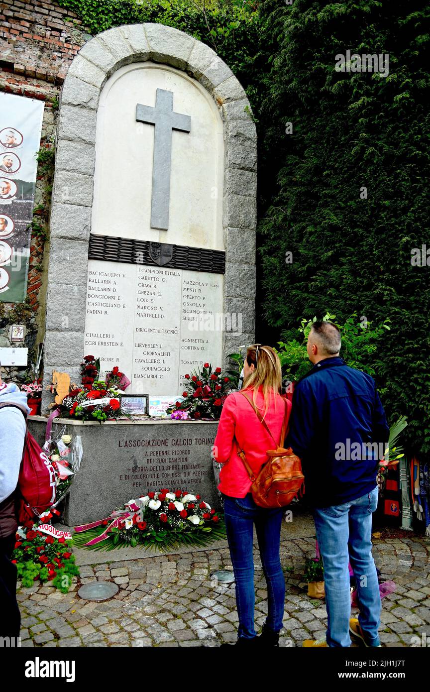 The people near a gravestone in memory of the legendary Grande Torino ...