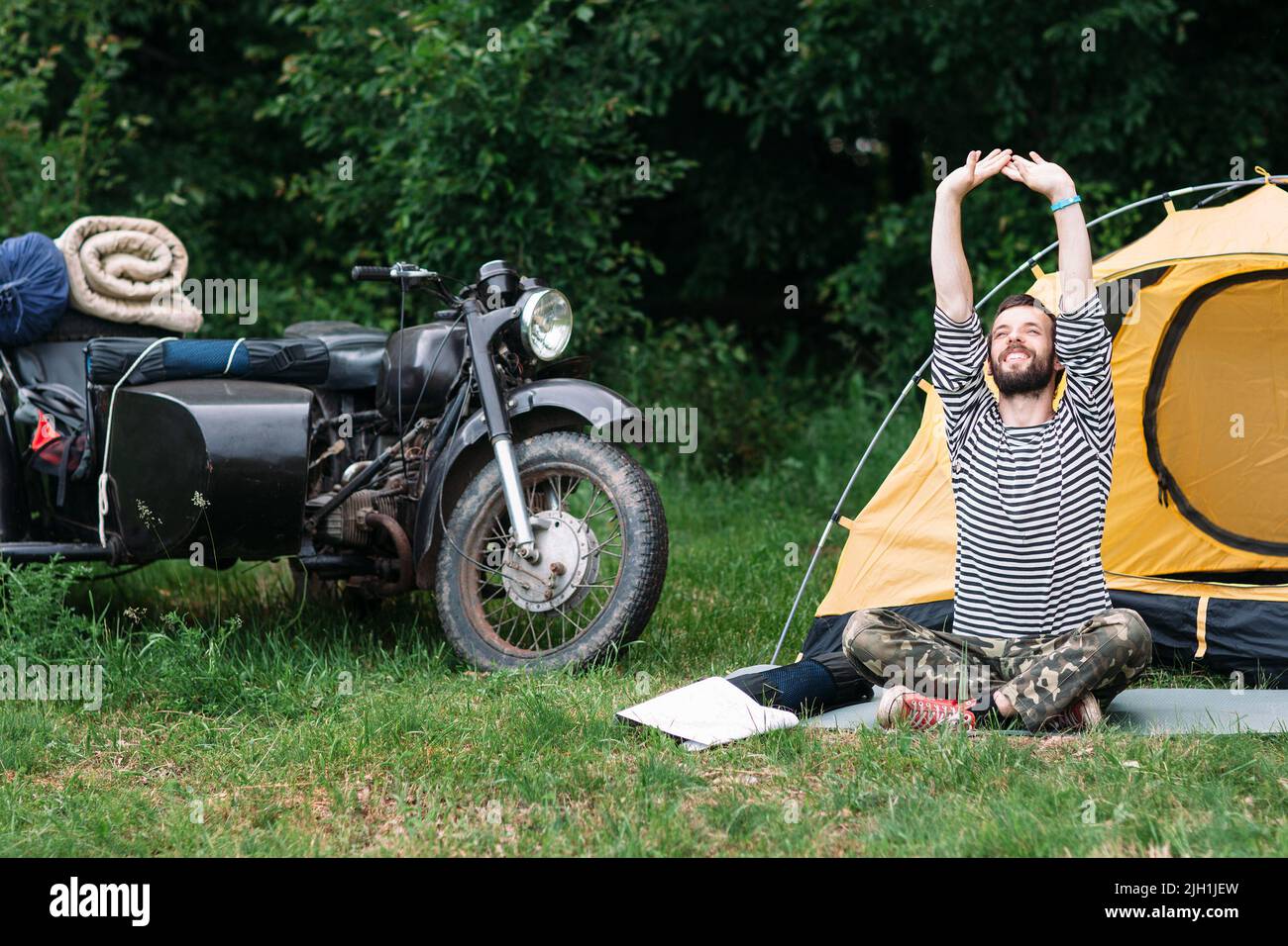 Happy man relaxing in forest on summer morning Stock Photo - Alamy