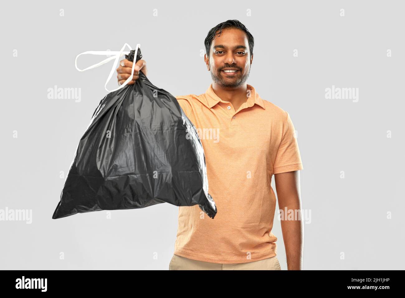smiling indian man holding trash bag Stock Photo - Alamy