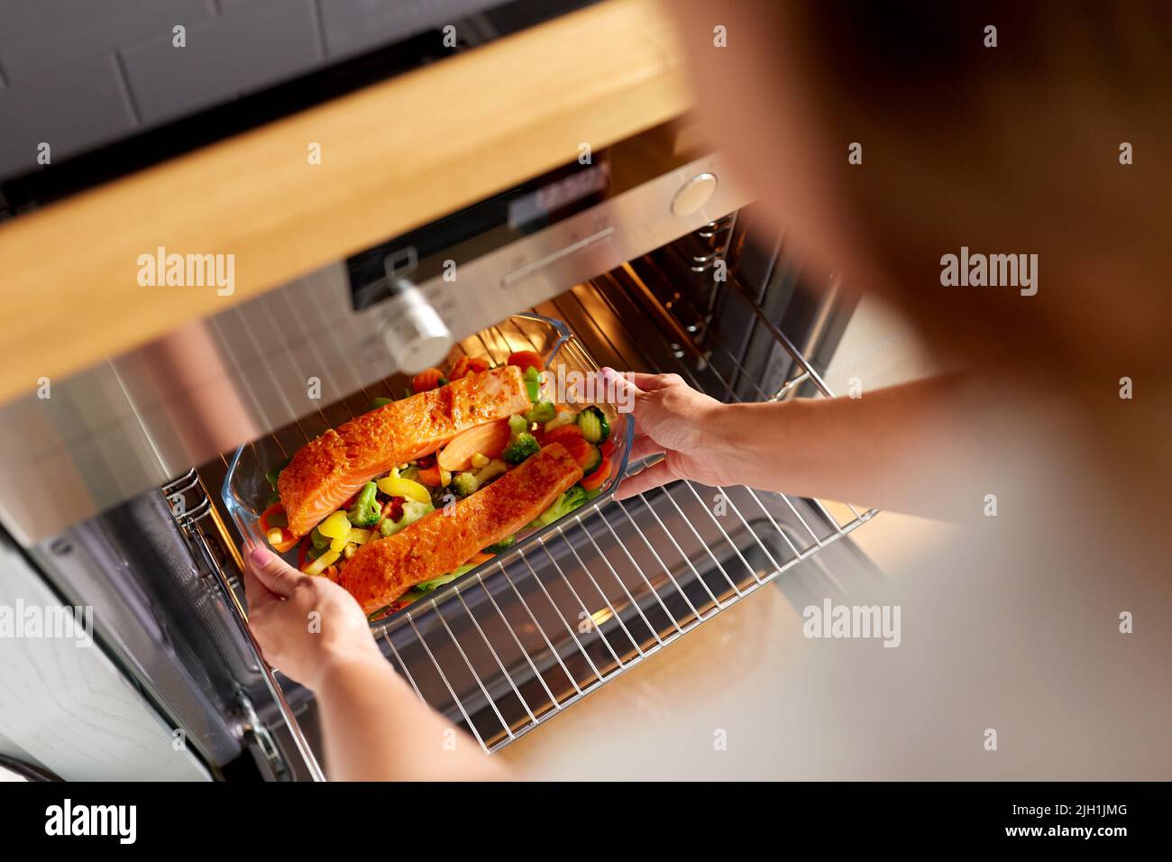 Woman opening oven hi-res stock photography and images - Alamy