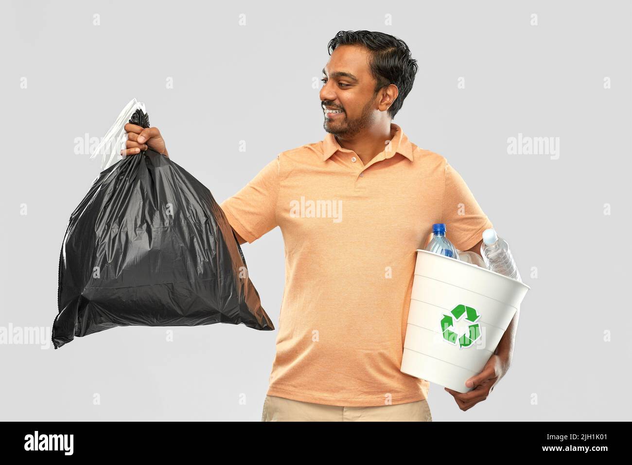 smiling indian man sorting paper and plastic waste Stock Photo - Alamy